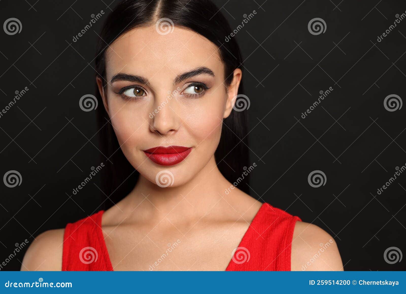 Portrait Of Young Woman Wearing Beautiful Red Lipstick On Black