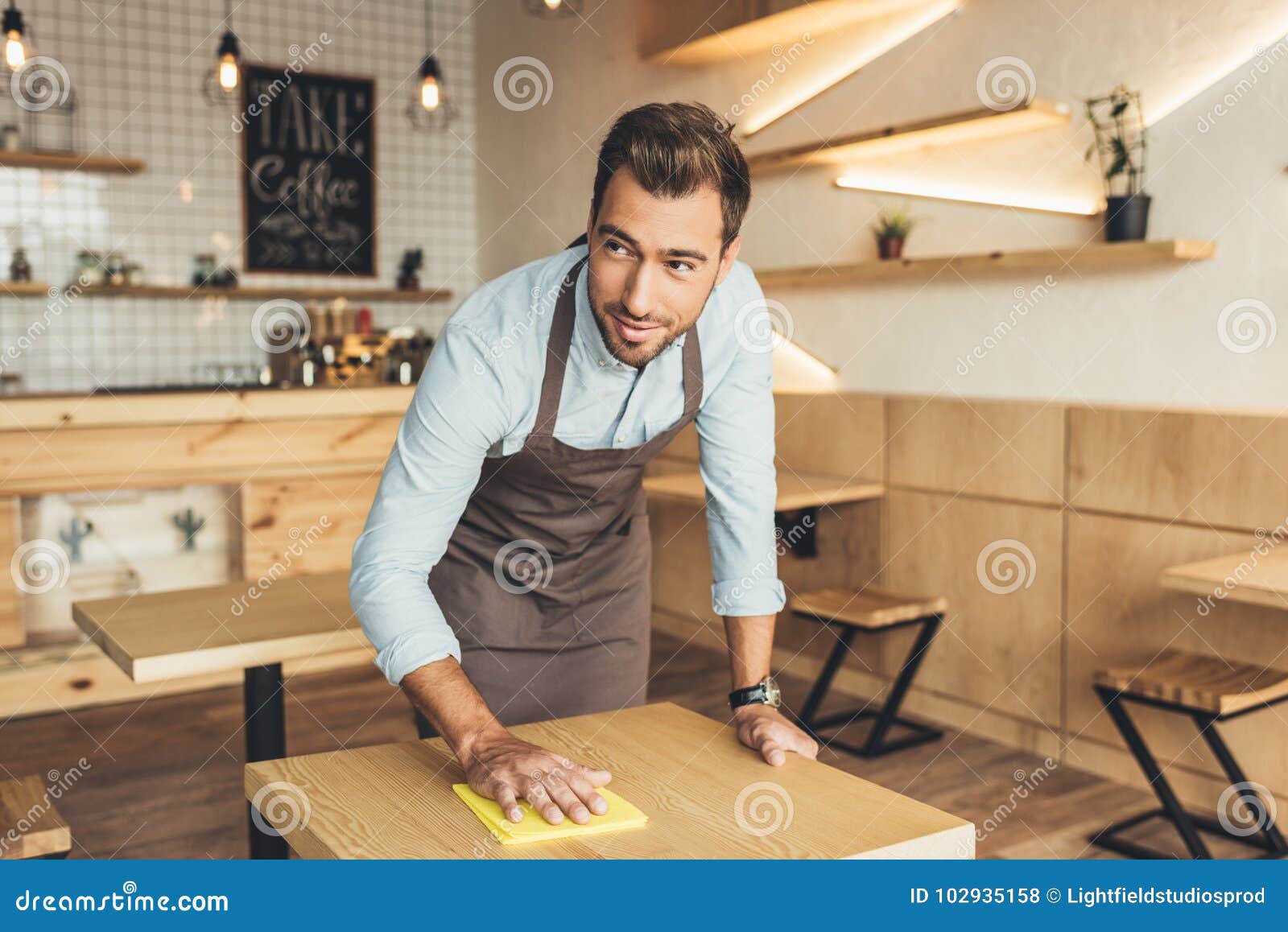 Worker Cleaning Table in Cafe Stock Photo - Image of clothing, clothes ...