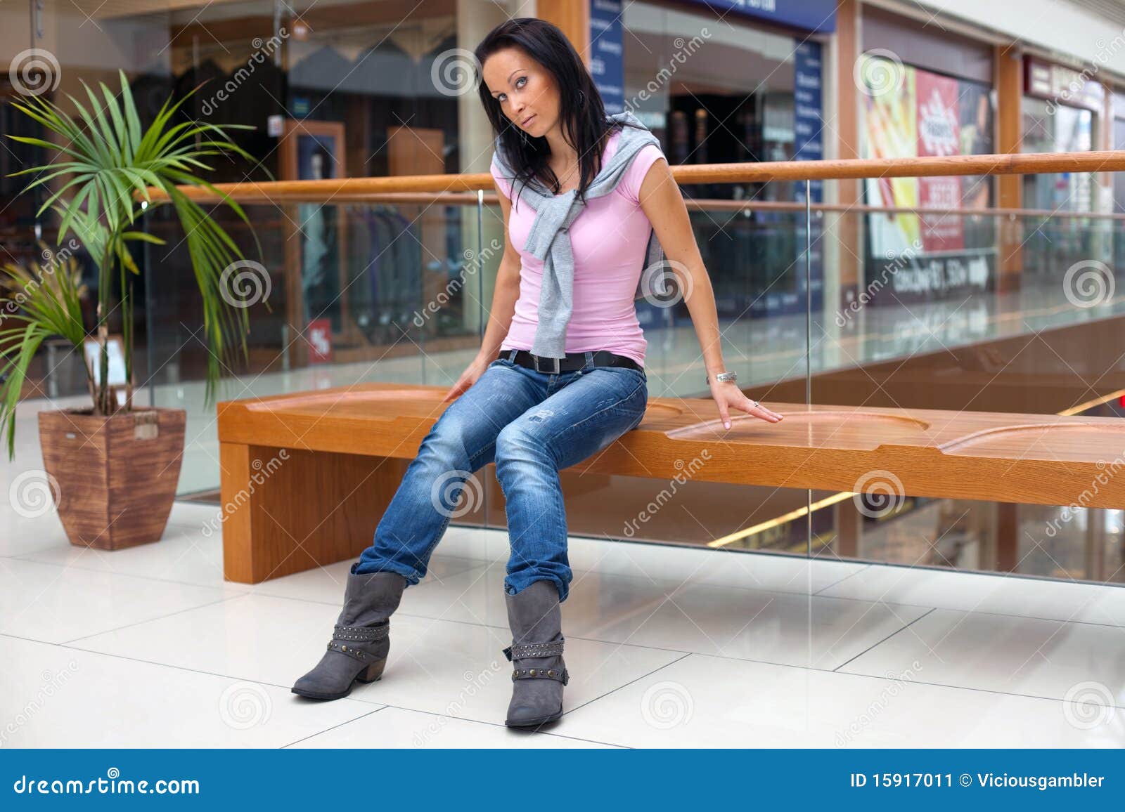 Posing Brunette on Bench Over Mall Background Stock Image - Image of ...