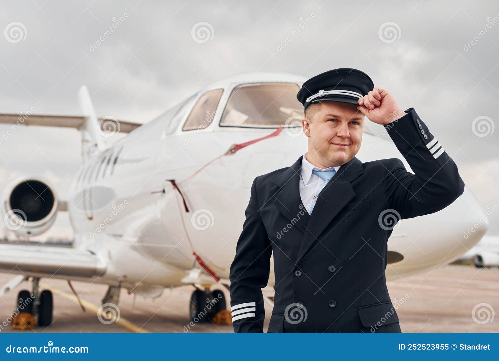 Posing for a Camera. Experienced Pilot in Uniform Standing Outside Near ...