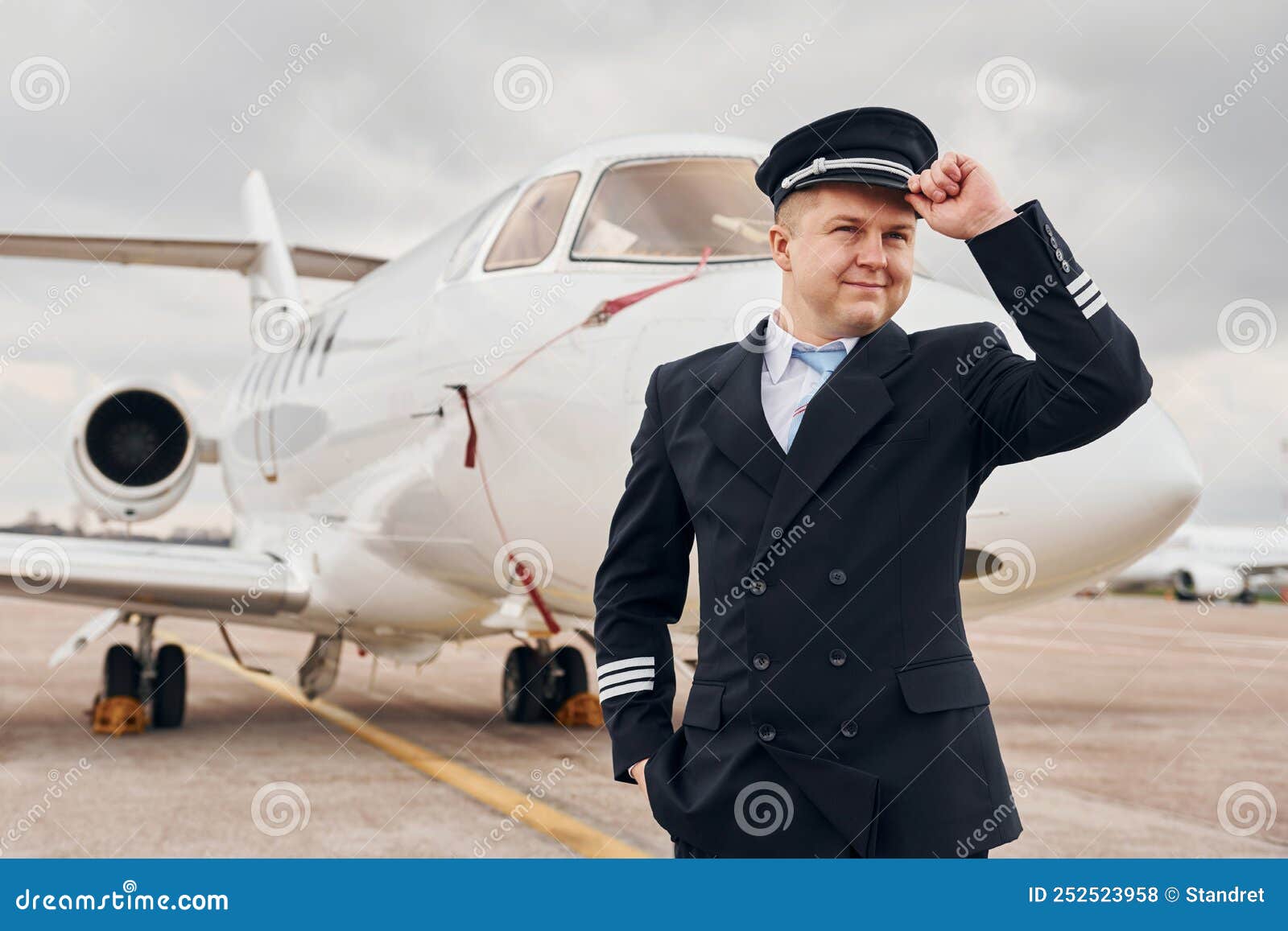 Posing for a Camera. Experienced Pilot in Uniform Standing Outside Near ...
