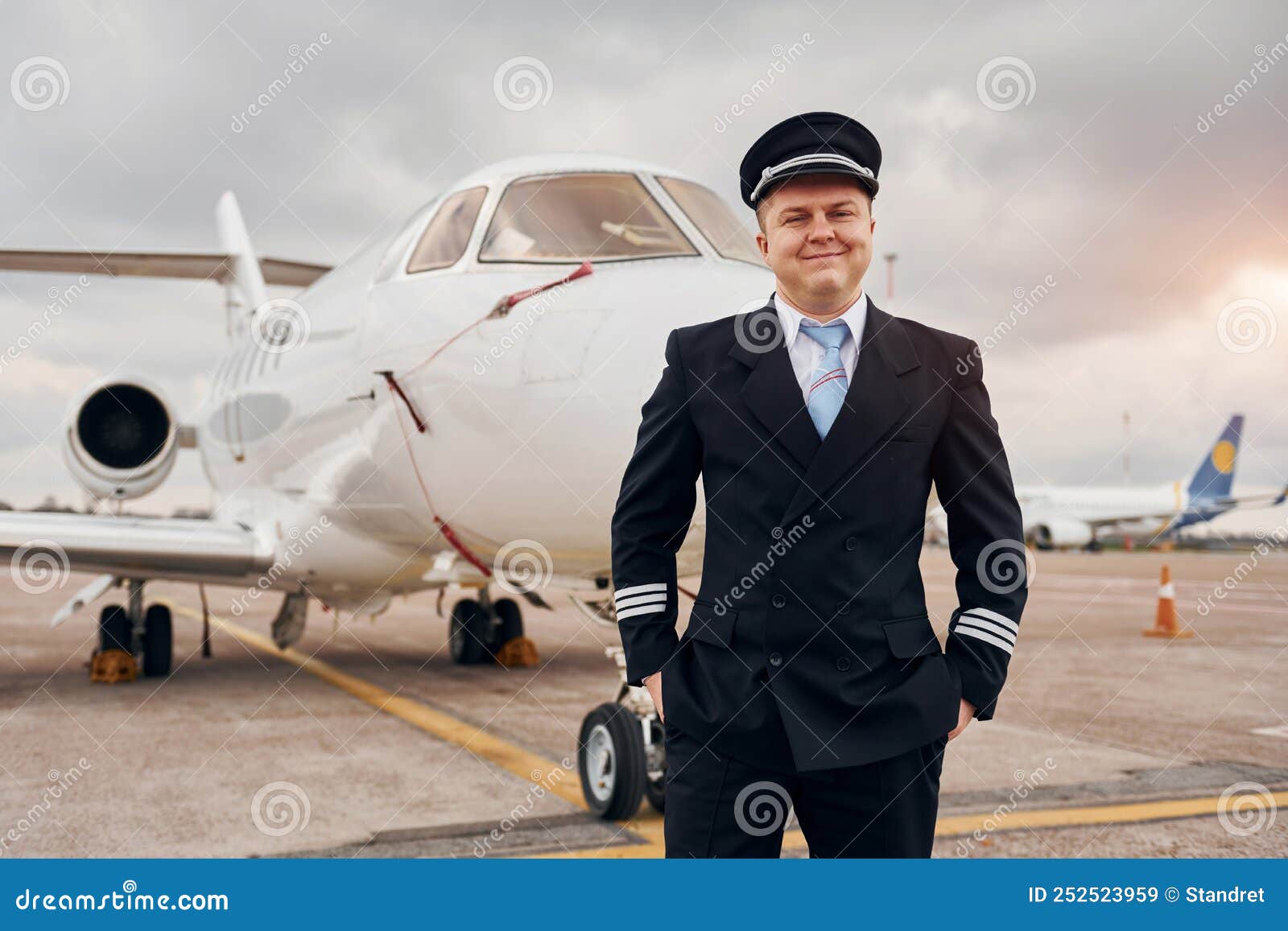 Posing for a Camera. Experienced Pilot in Uniform Standing Outside Near ...