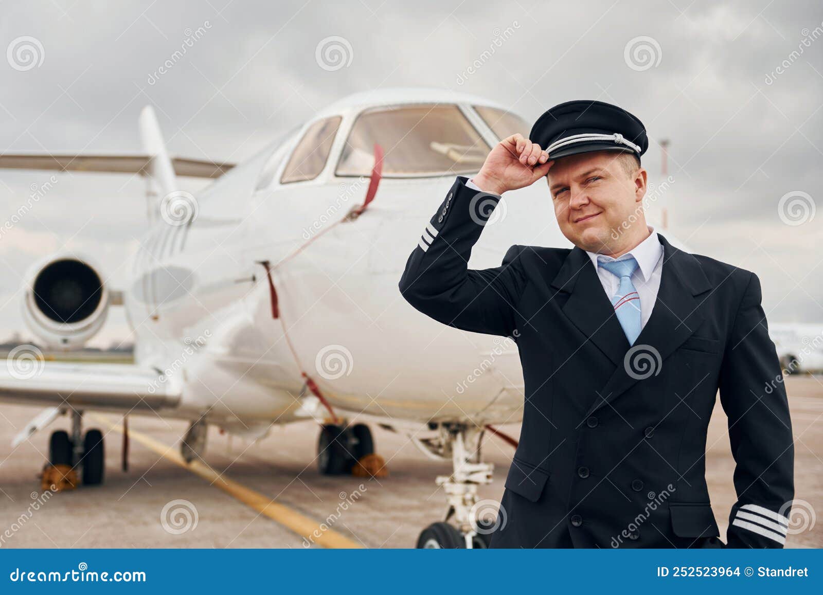 Posing for a Camera. Experienced Pilot in Uniform Standing Outside Near ...