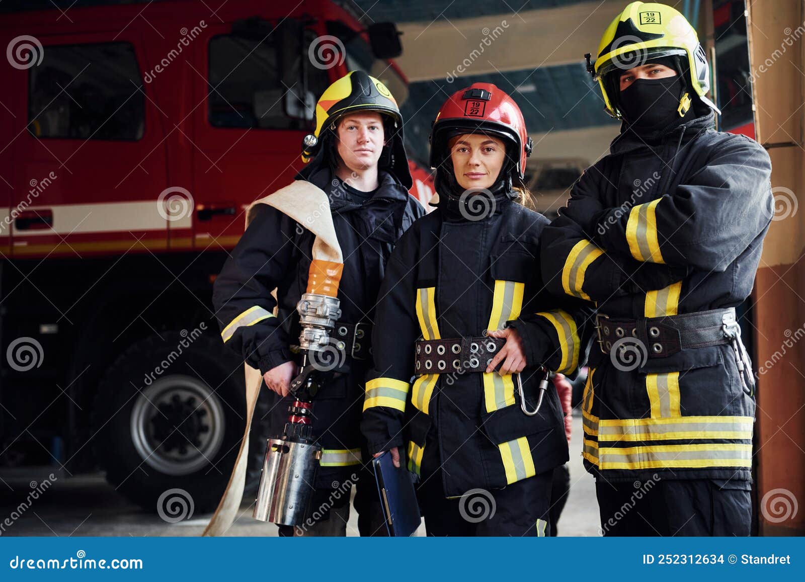 Posing for a Camera. Group of Firefighters in Protective Uniform that ...
