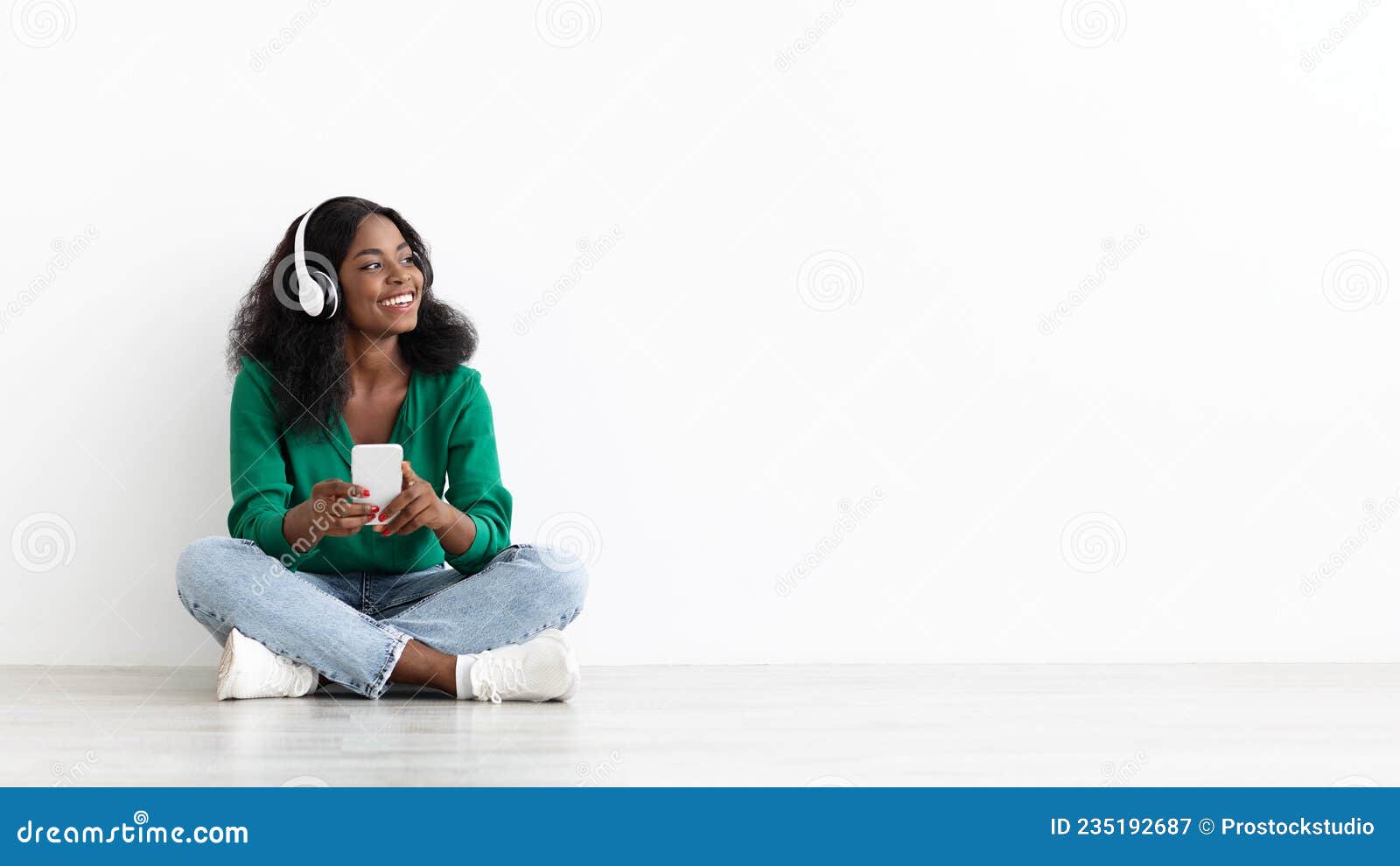 Positive African American Woman With Wireless Headset And Smartphone