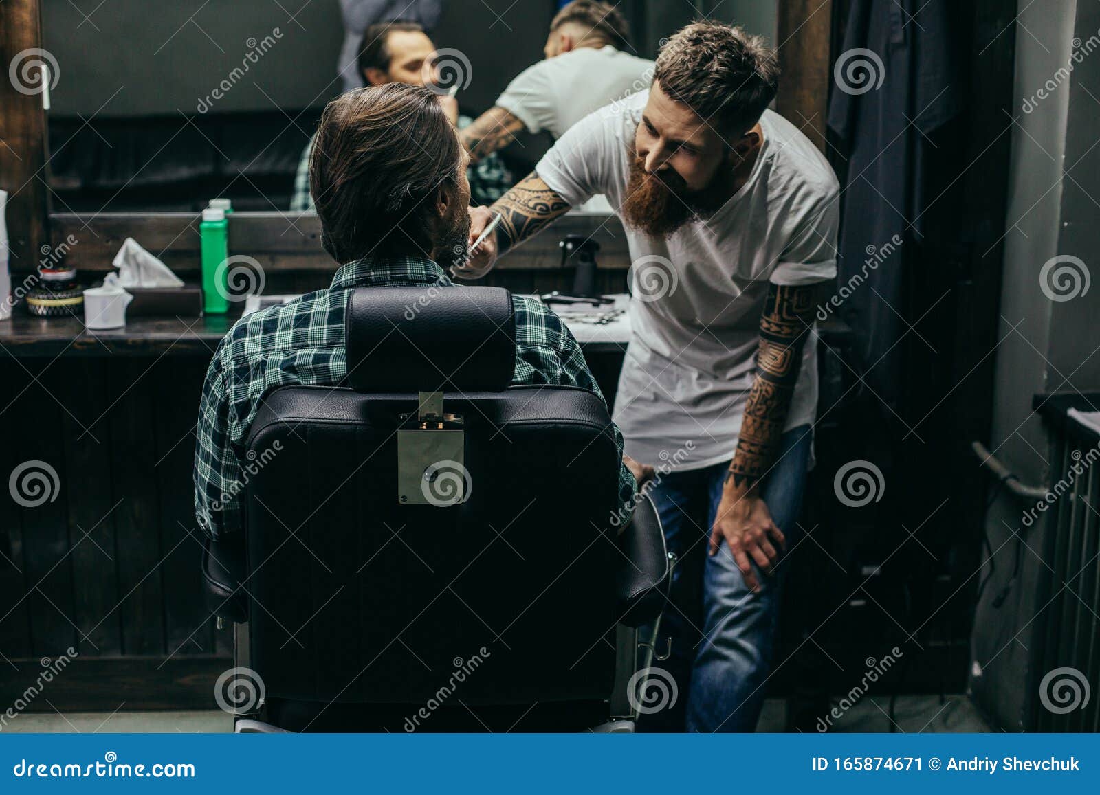 Positive Bearded Barber Smiling and Carefully Brushing Beard of Client ... Positive Bearded Barber Smiling and Carefully Brushing Beard of Client ...