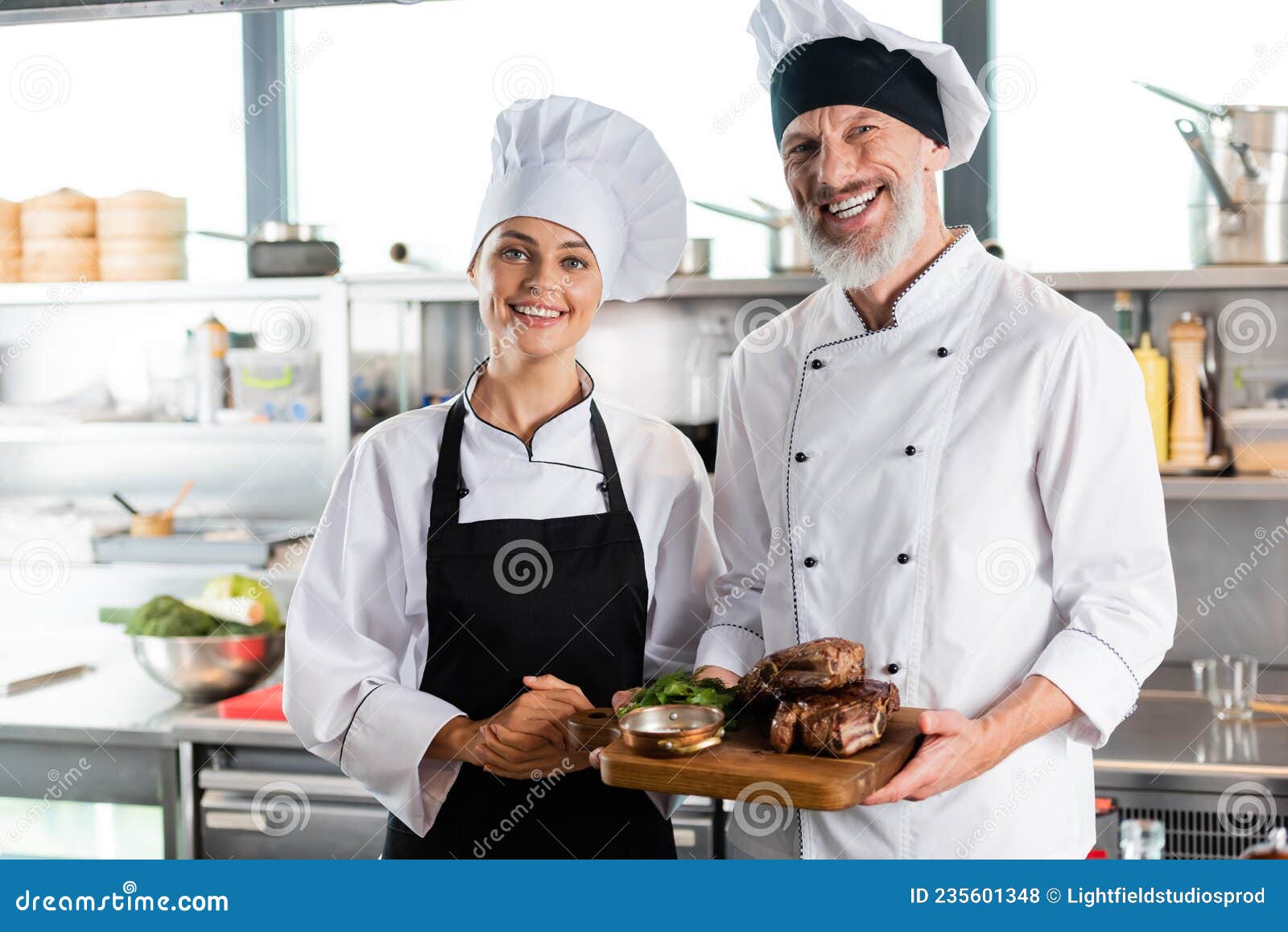 Positive Chefs Smiling at Camera while Stock Photo - Image of people ...