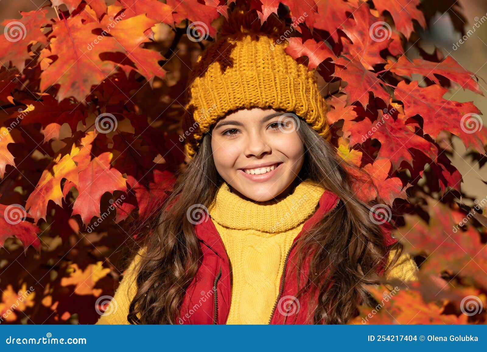 Positive Child in Hat Standing at Autumn Leaves Stock Photo - Image of ...