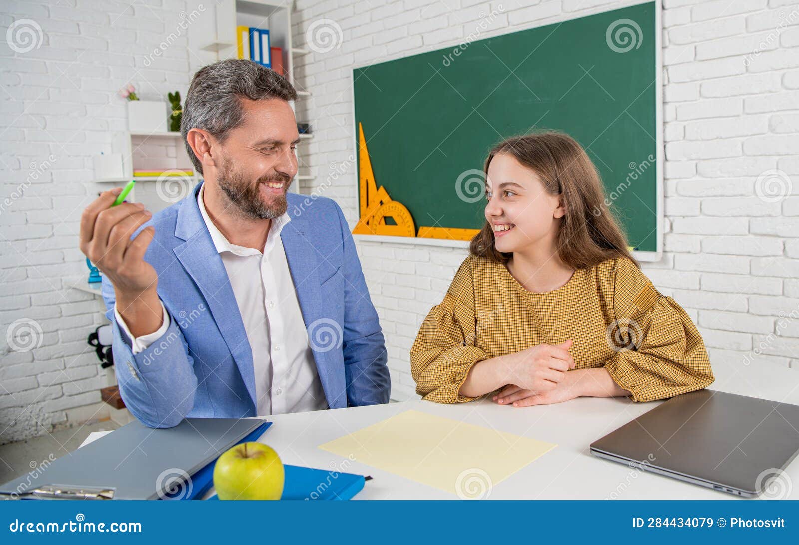 Positive Child Study in Classroom with Tutor Stock Image - Image of ...