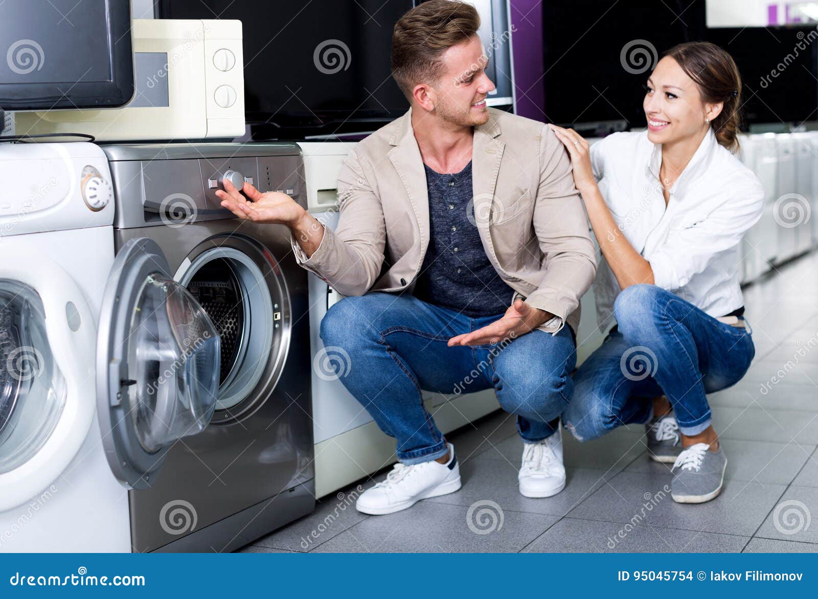 Positive Customers Looking at Laundry Machine Stock Photo - Image of ...