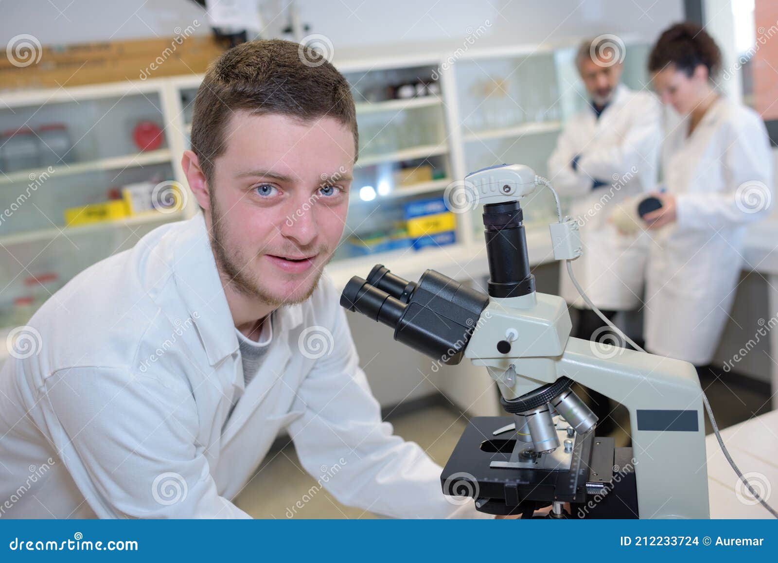 Positive Delighted Scientist Looking into Microscope Stock Photo ...