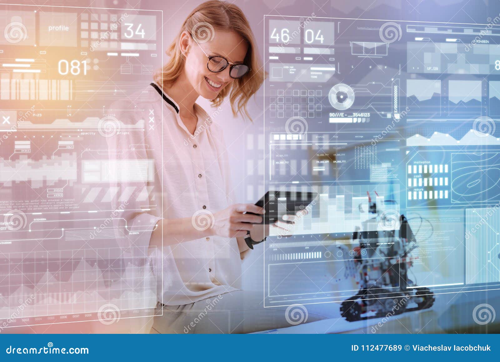 Positive Engineer Holding a Modern Tablet while Testing a New Robot ...