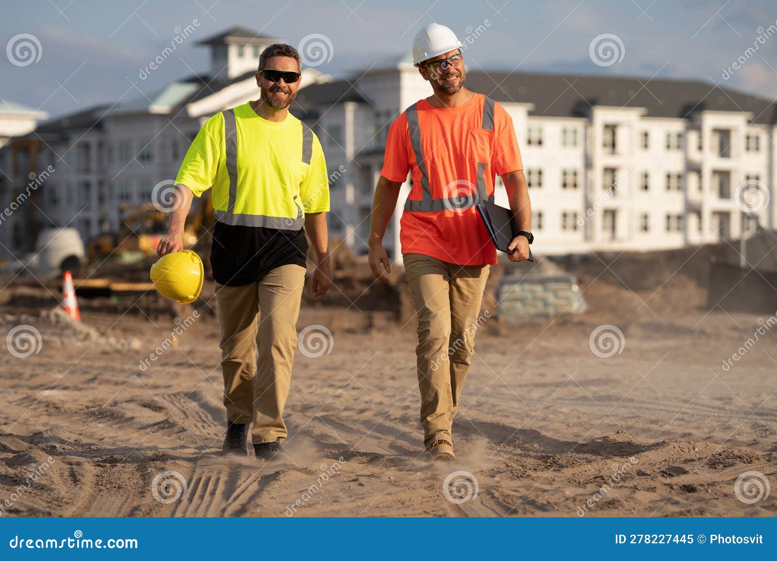 Positive Engineer Men Walking at Construction Site. Engineer Men at ...