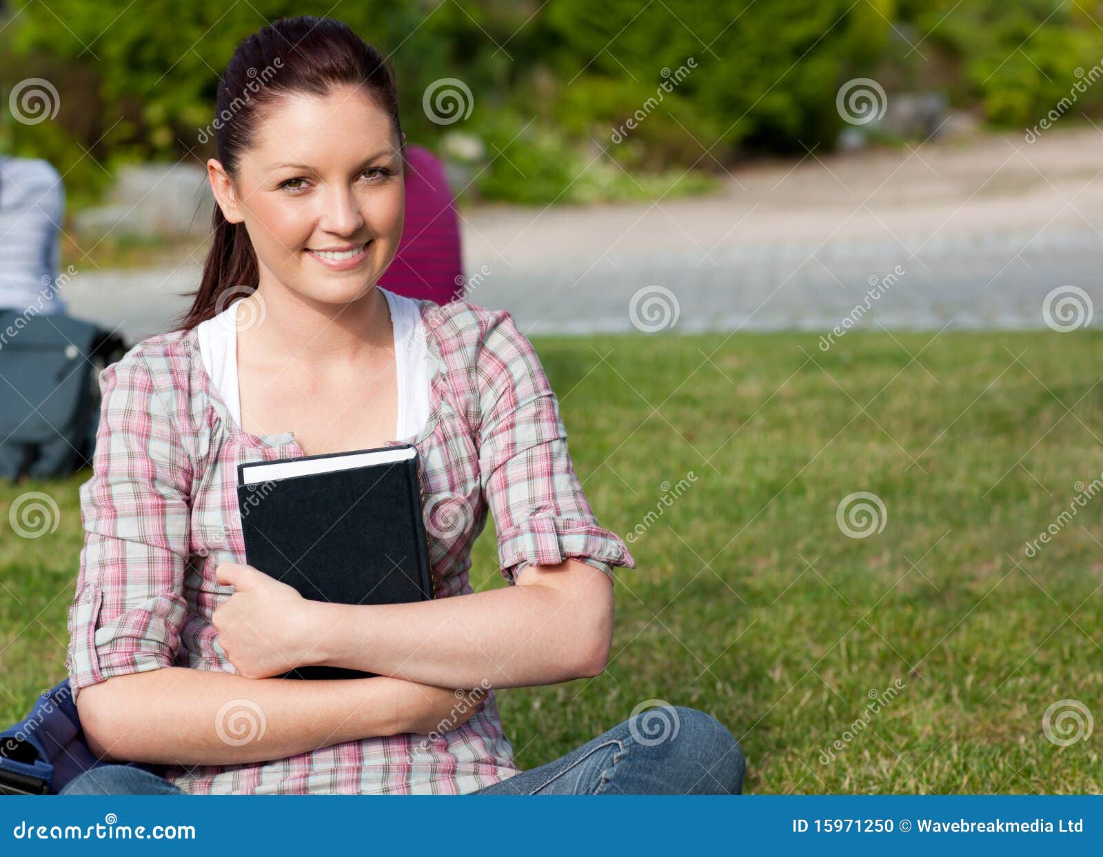 Positive Female Student Holding a Book in a Park Stock Photo - Image of ...