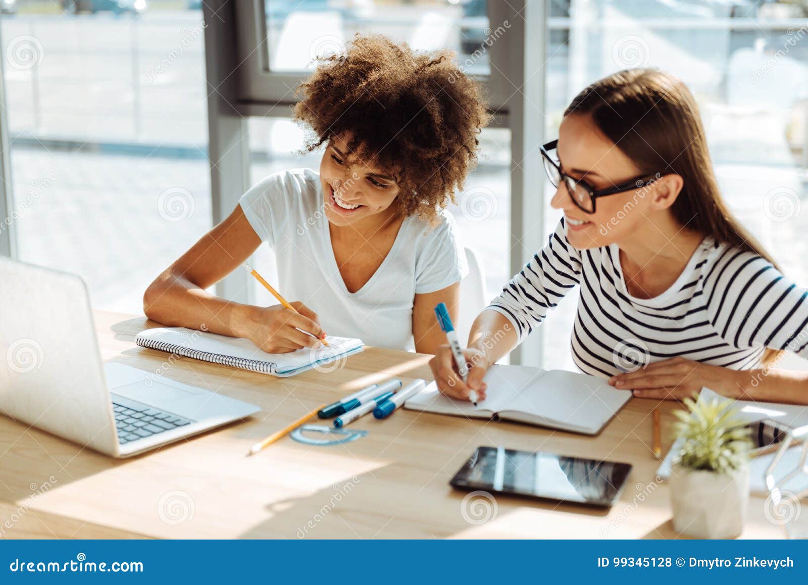 Positive Female Students Doing Their Homework Stock Photo - Image of ...