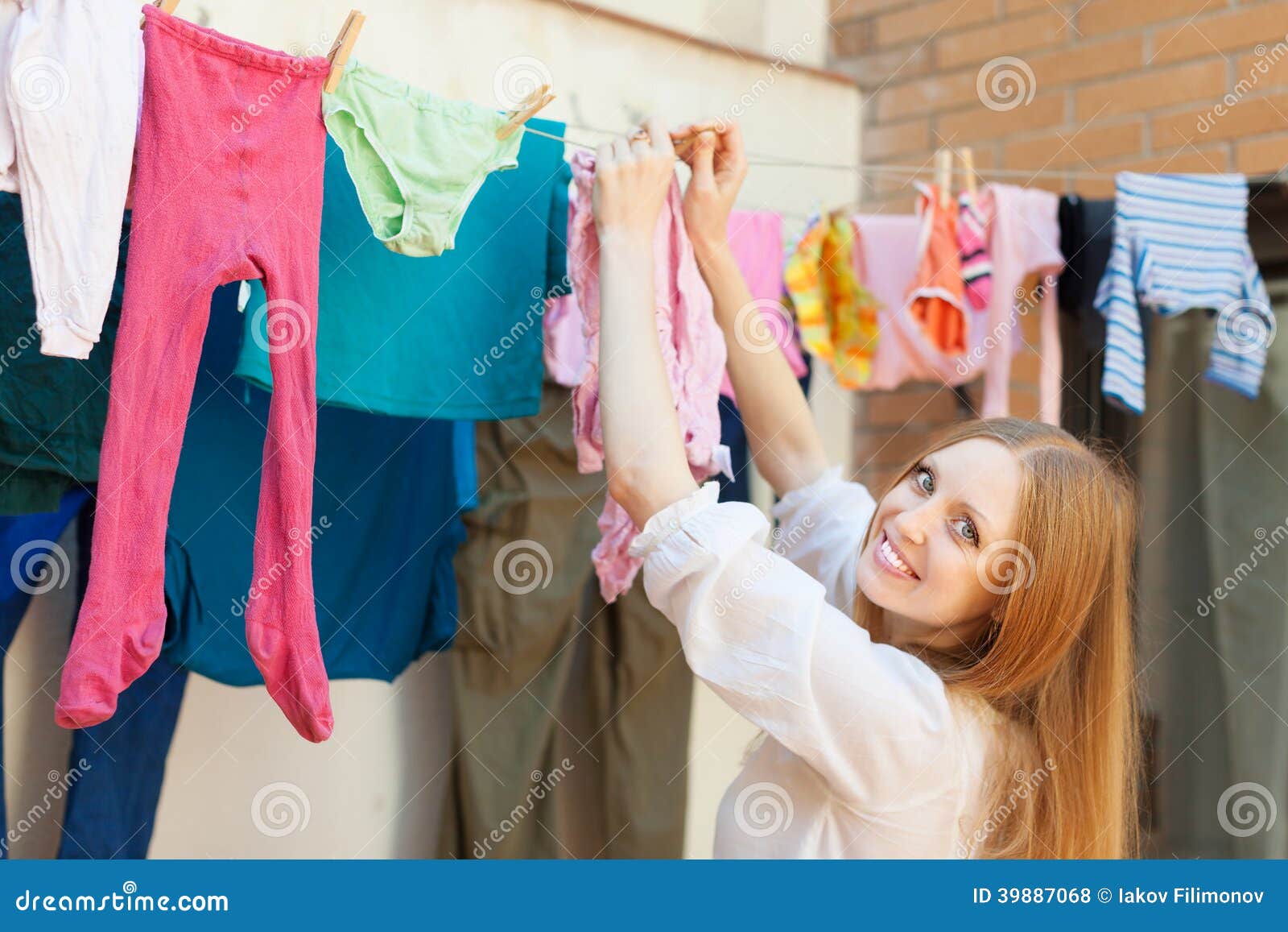 Positive Girl Drying Clothes Stock Photo - Image of outdoors, lifestyle ...