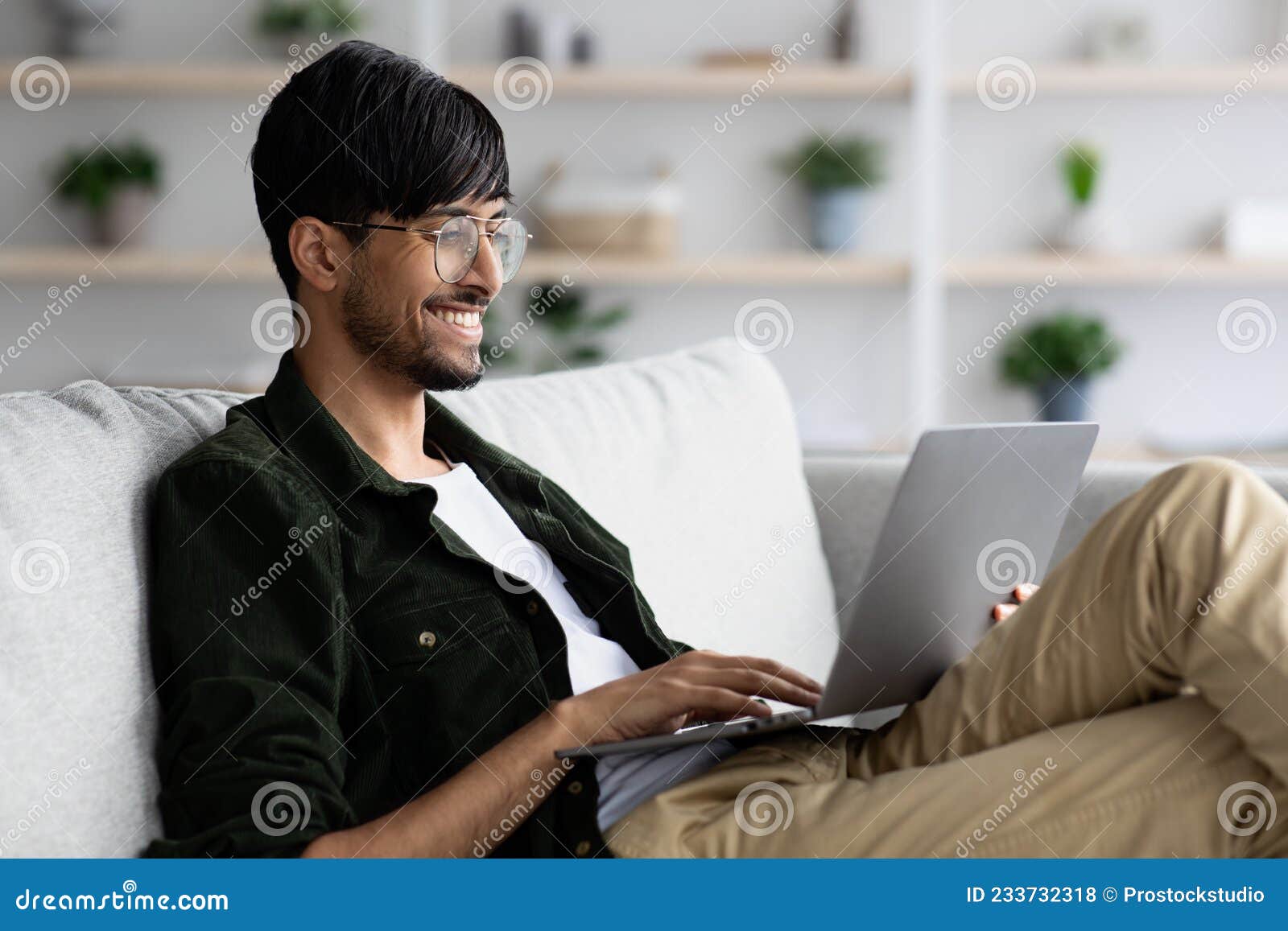 Positive Indian Guy Chilling at Home, Using Laptop Stock Photo - Image ...