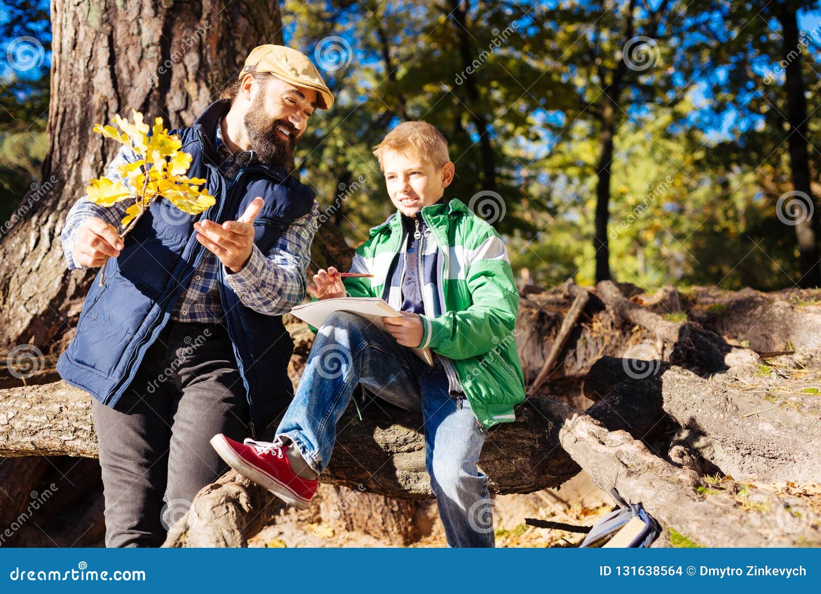 Positive Intelligent Boy Taking Notes in His Notebook Stock Photo ...