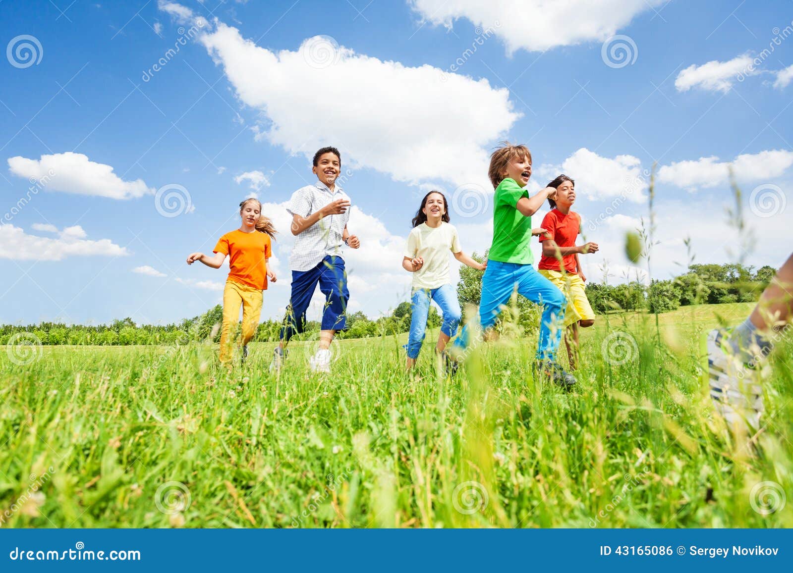 Positive Kids Playing and Running in the Field Stock Photo - Image of ...