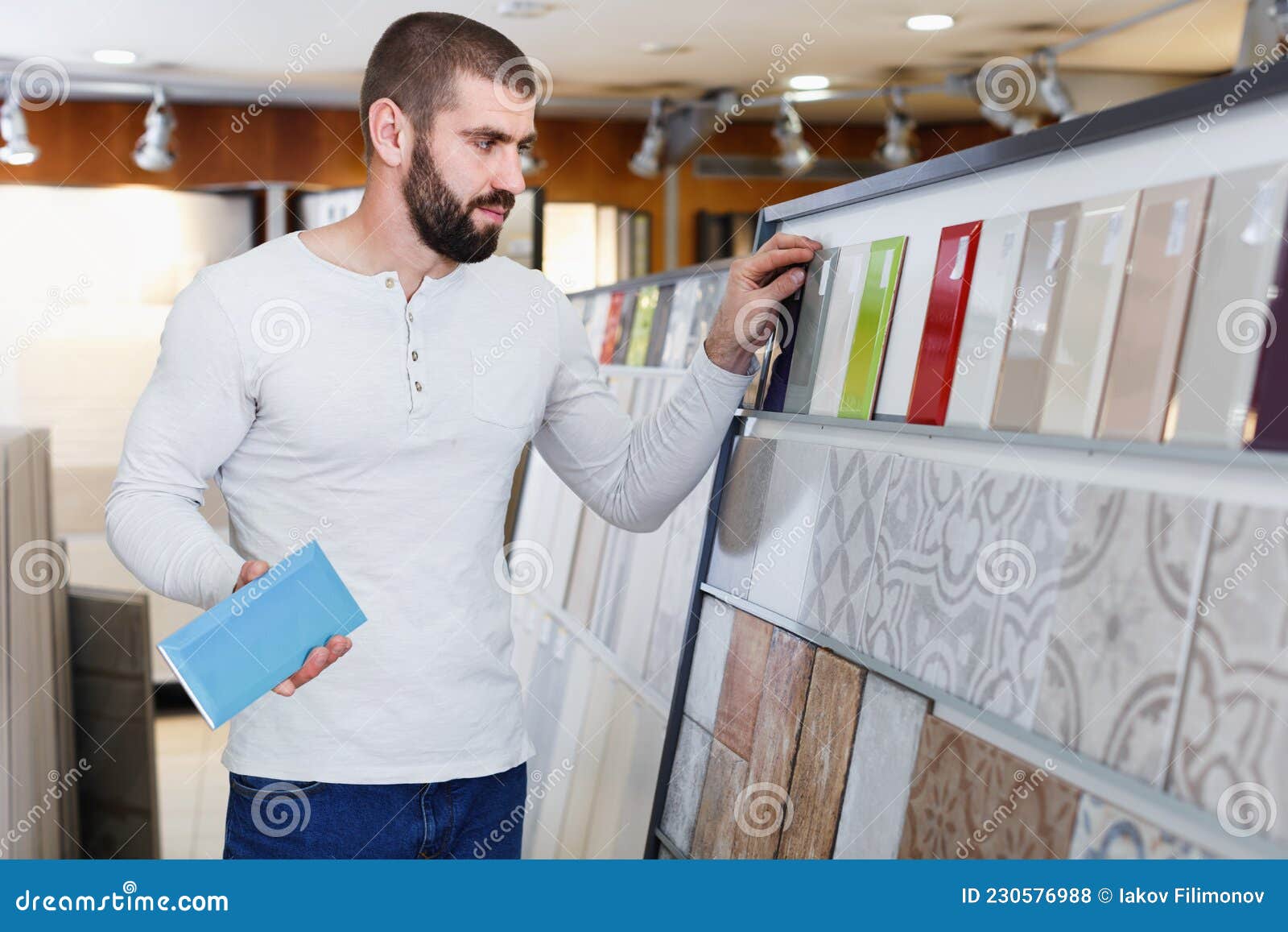 Positive Man Holding Sample of Kitchen Ceramic Tile in Modern Store ...
