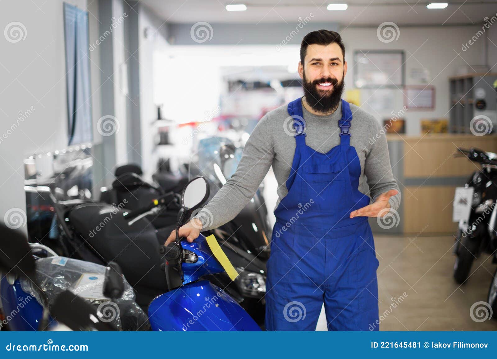 Positive Man Worker Demonstrating Motorbikes Stock Image - Image of ...