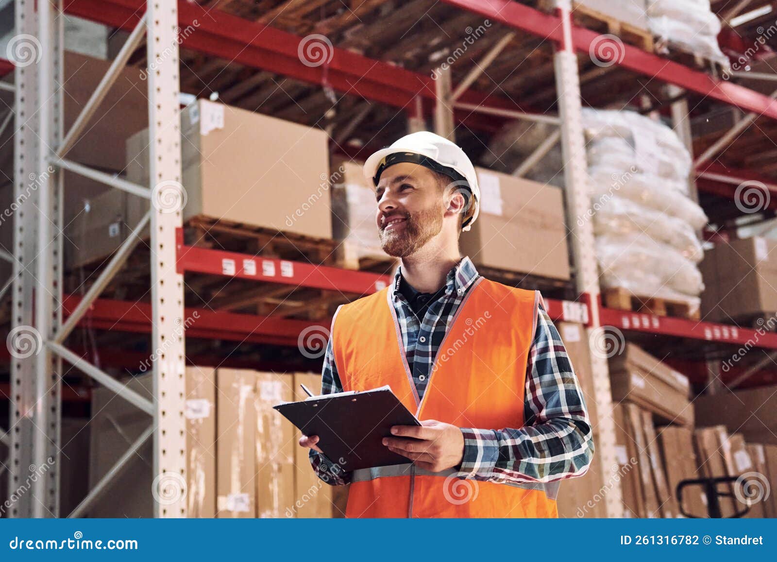 Positive Mood. Employee in Uniform is Working in the Storage at Daytime ...