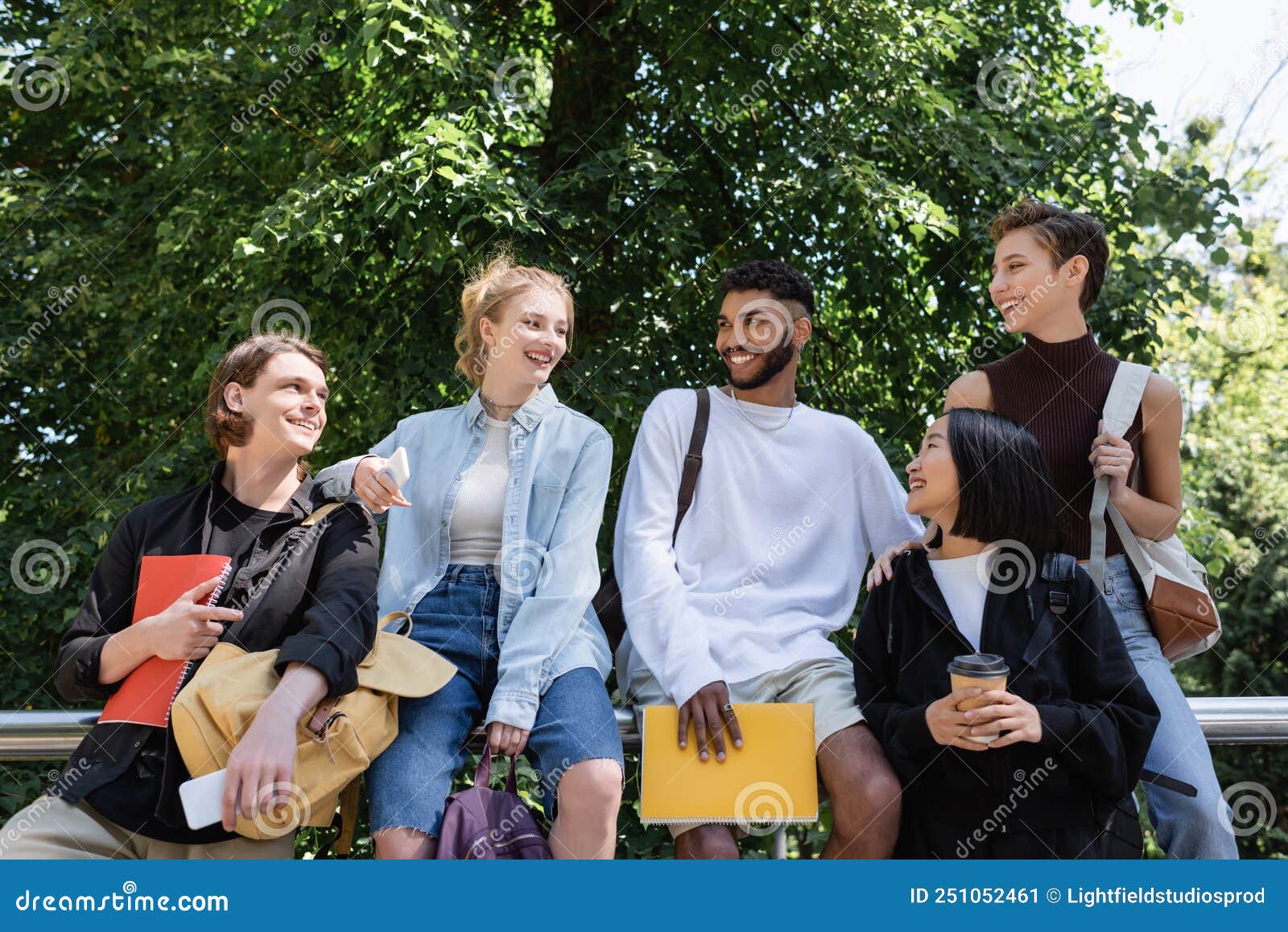 Positive Multicultural Students with Notebooks Talking Stock Image ...