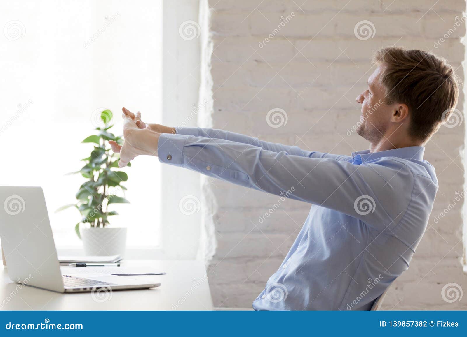 Worker Doing Effective Stretching Exercises during the Working Day ...