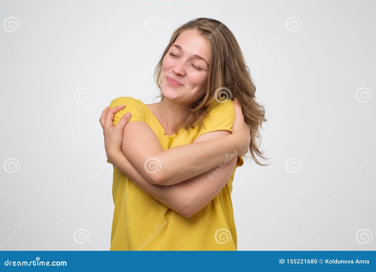 Positive Relaxed Young Woman Closing Eyes With Pleasure Keeping Arms