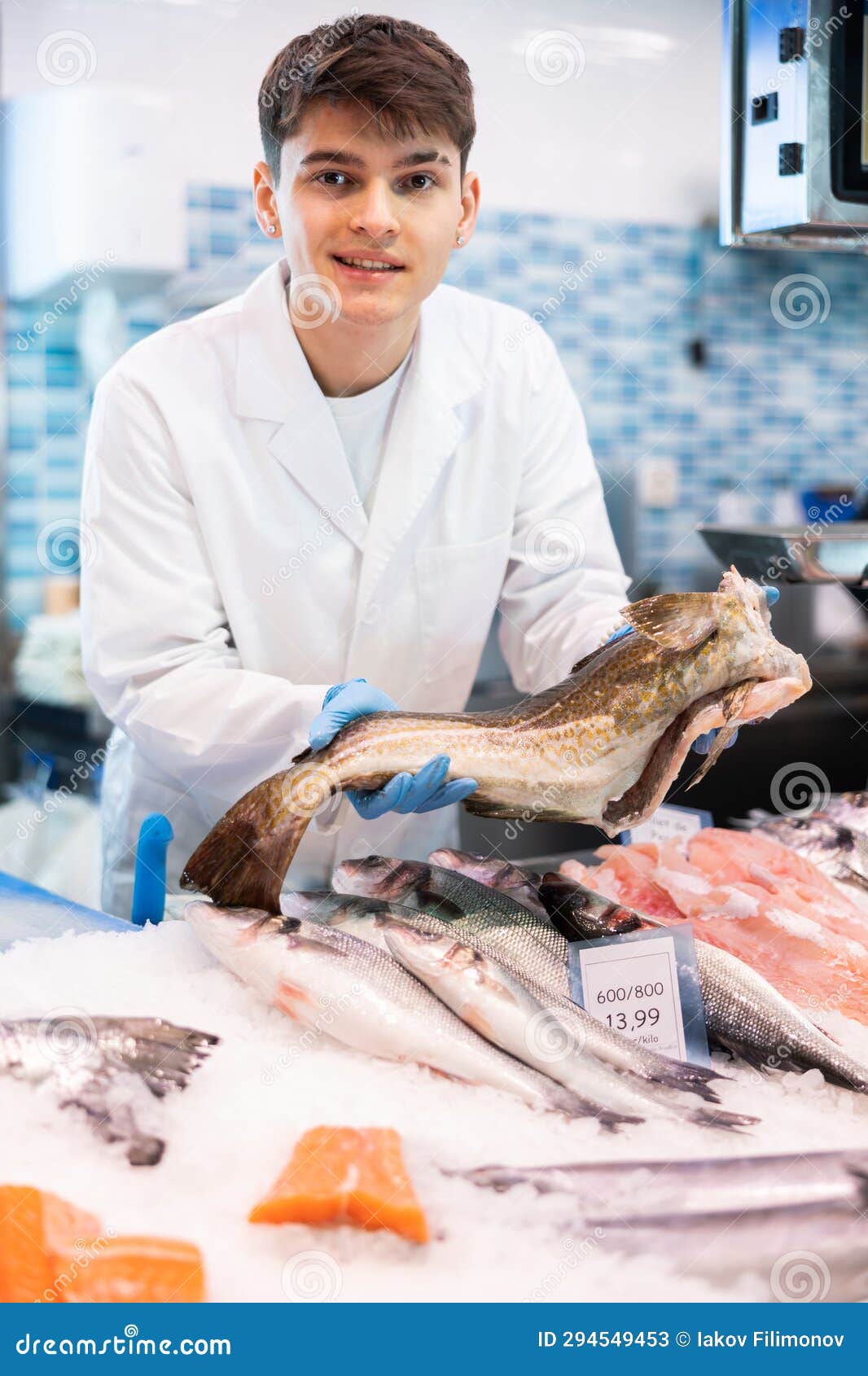 Positive Salesman Demonstrating Cod in Fish Store Stock Image - Image ...