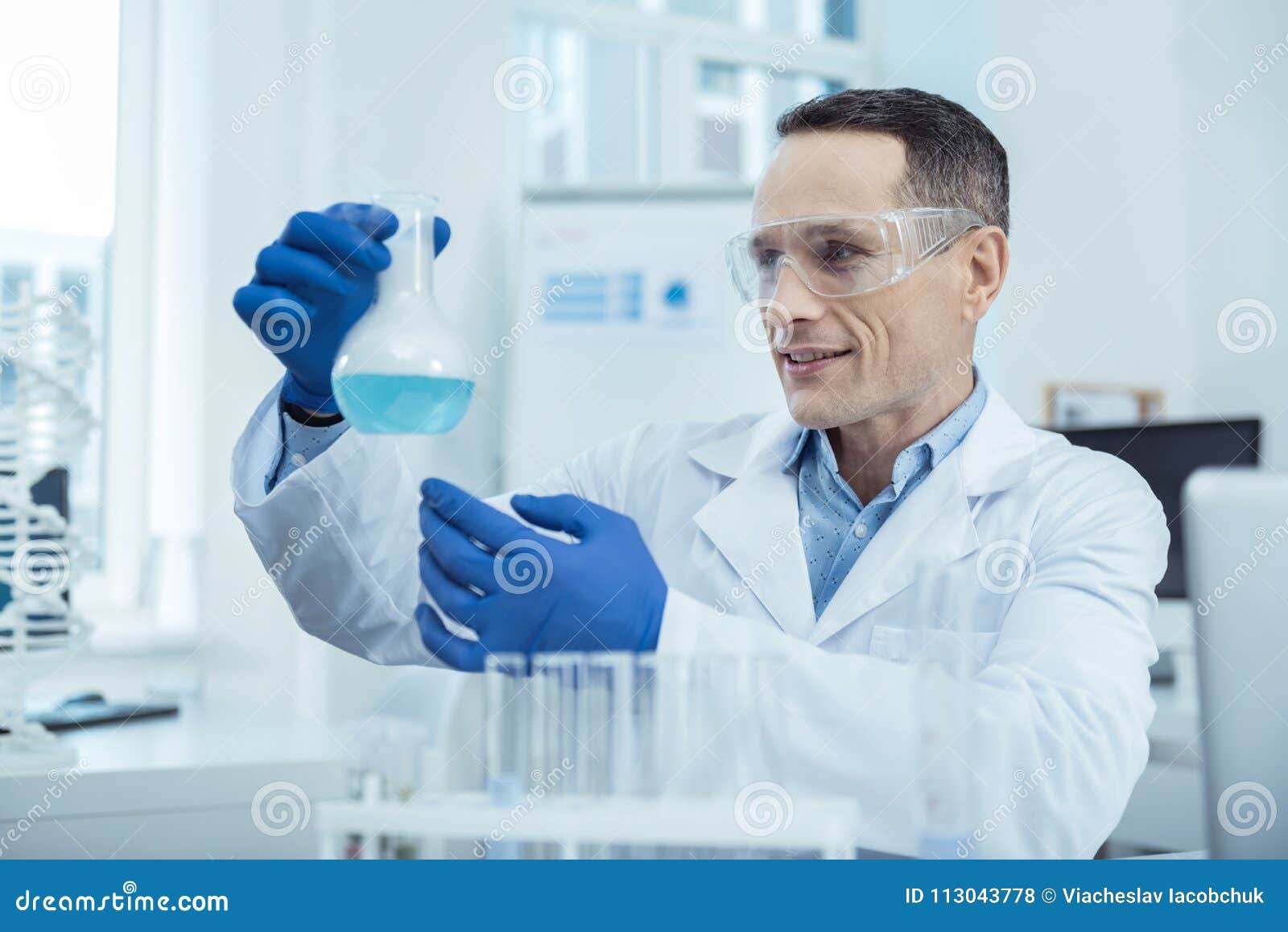 Positive Scientist Holding a Lab Flask Stock Photo - Image of ...