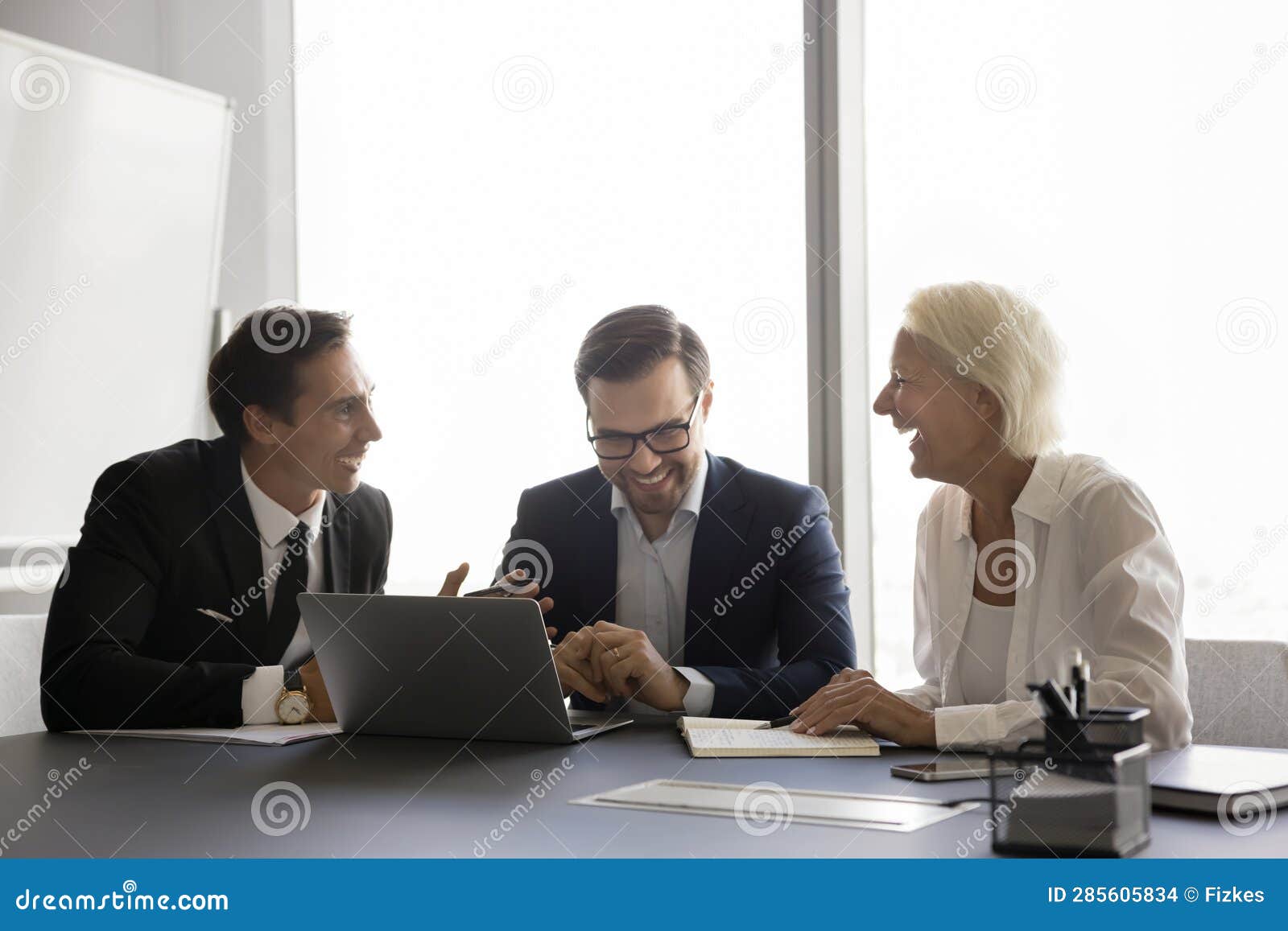 Positive Small Business Team Brainstorming at Laptop Stock Photo ...