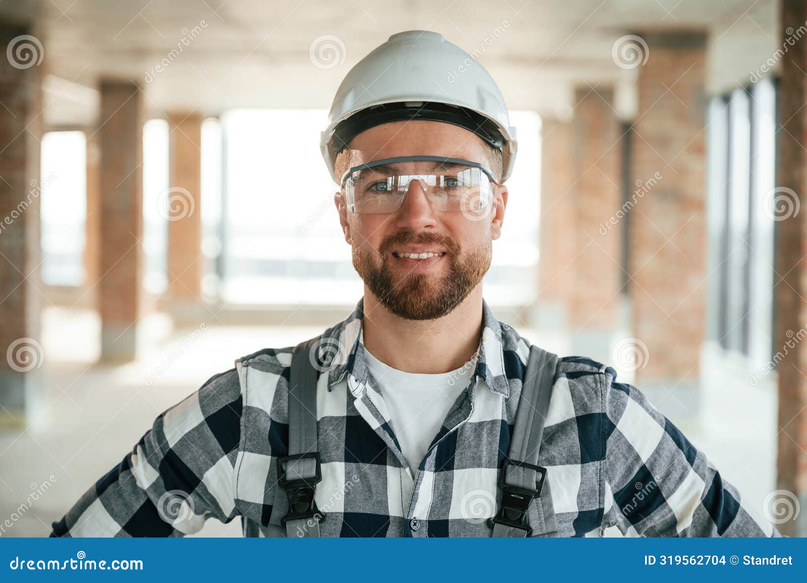 Positive Smiling Construction Worker in Uniform in Empty Unfinished ...