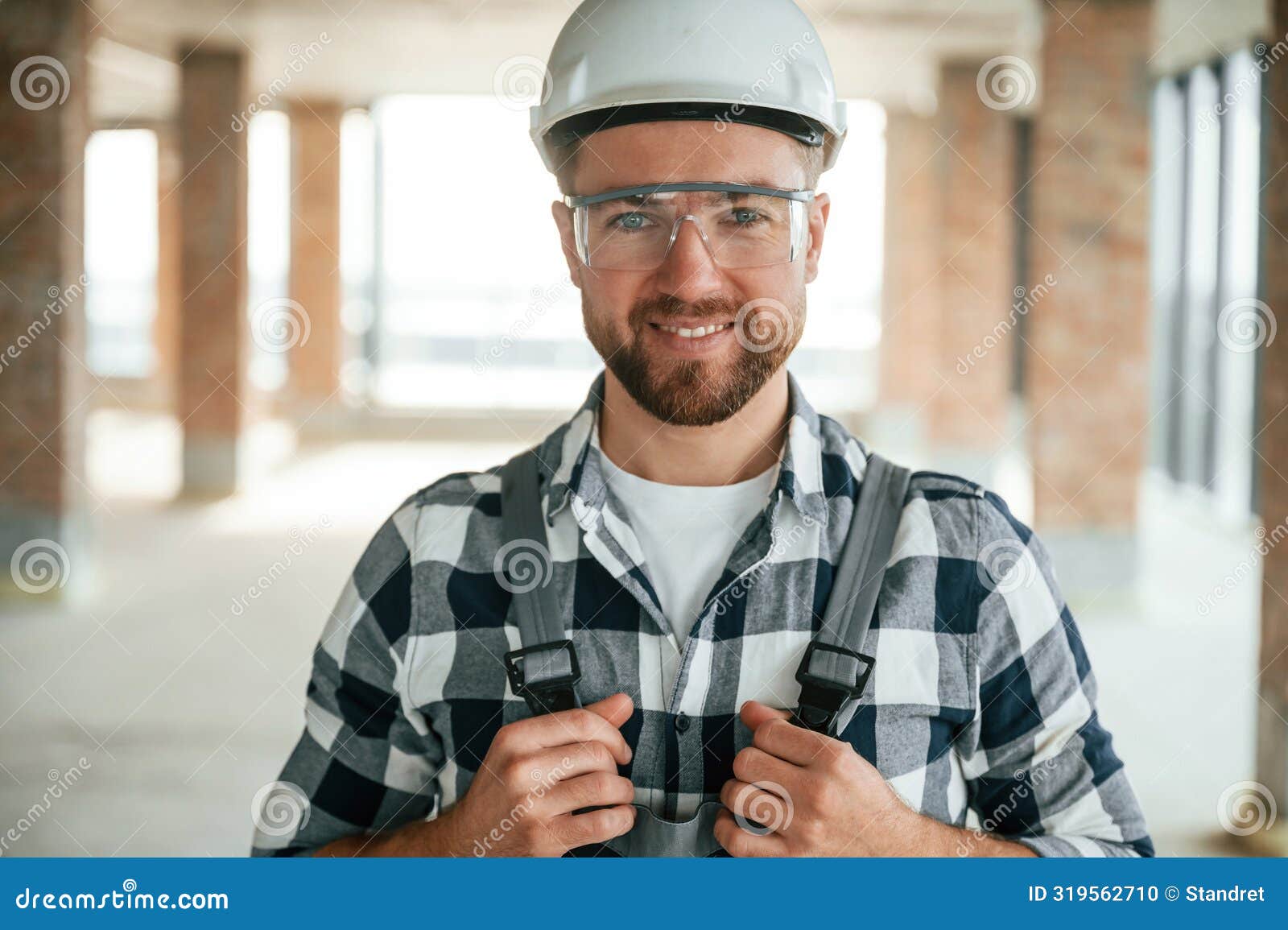 Positive Smiling Construction Worker in Uniform in Empty Unfinished ...