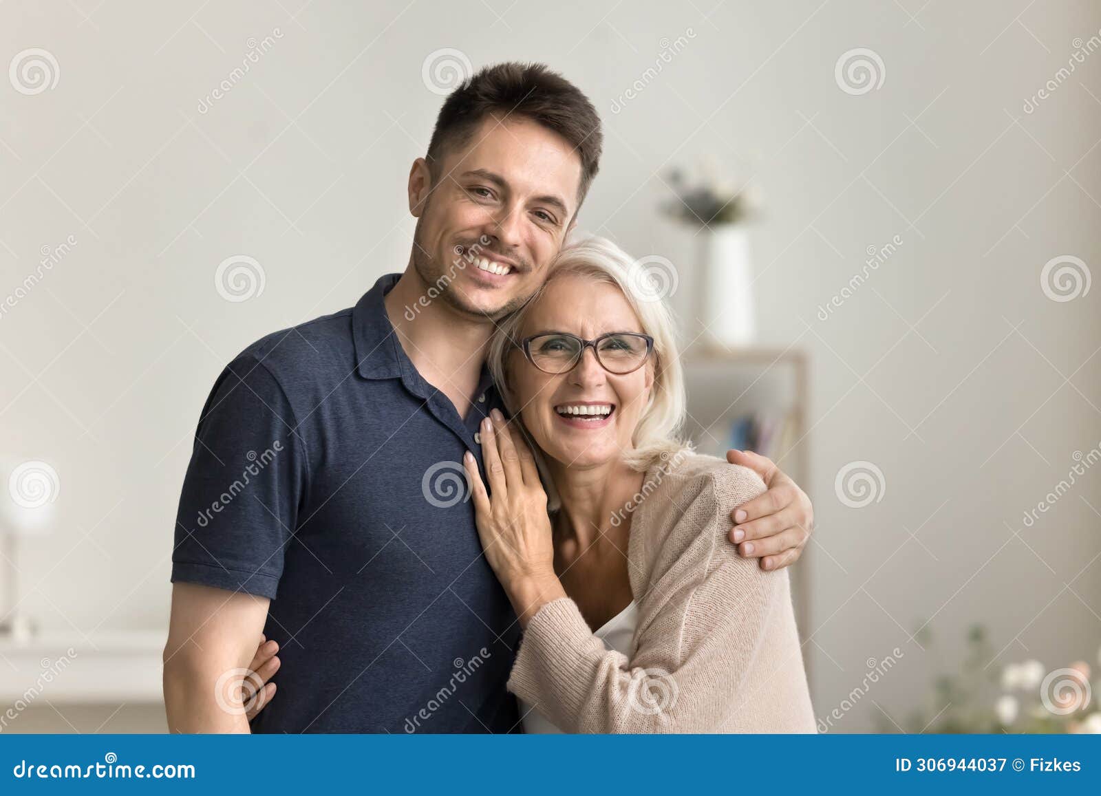 Positive Son Man And Happy Mature Mother Hugging At Home Stock Image