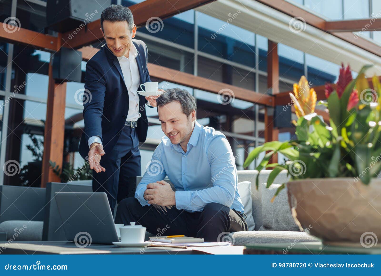 Positive Successful Businessman Standing Behind His Colleague Stock ... Positive Successful Businessman Standing Behind His Colleague Stock ...
