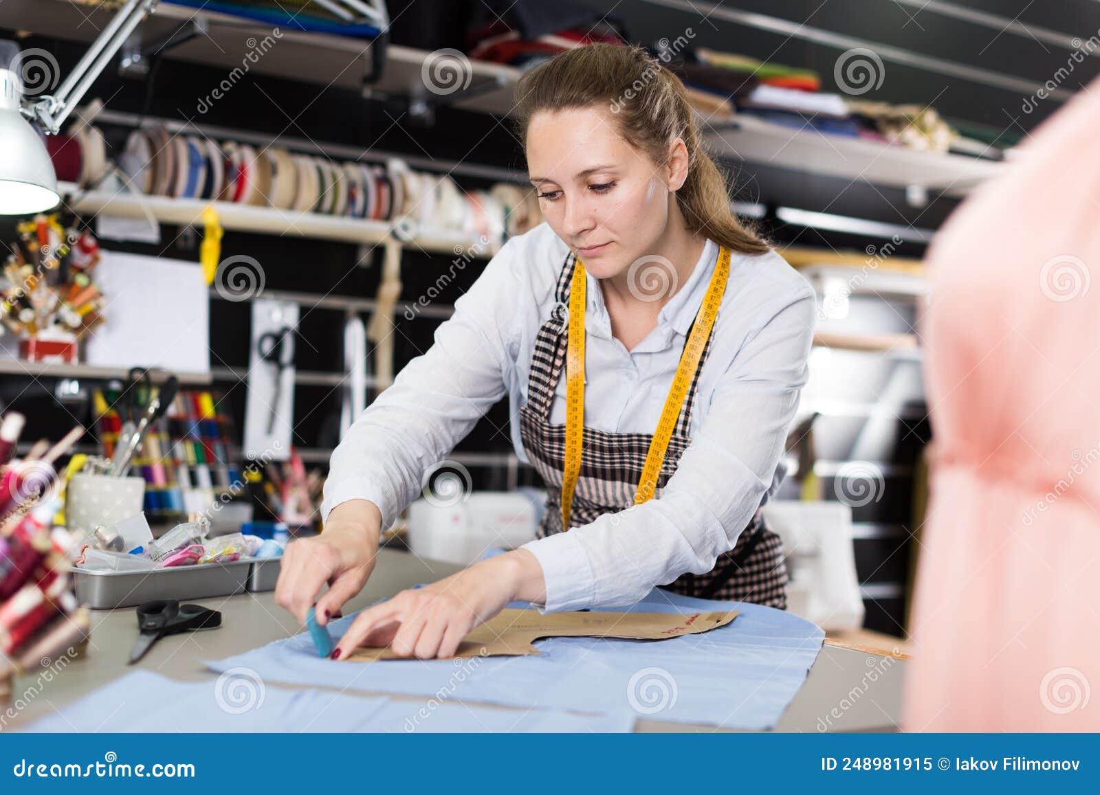 Positive Tailor Working with Marker for Modeling Clothes at Workshop ...