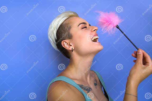 Positive Tattooed Woman Laughing Out Loud While Touching With Pink
