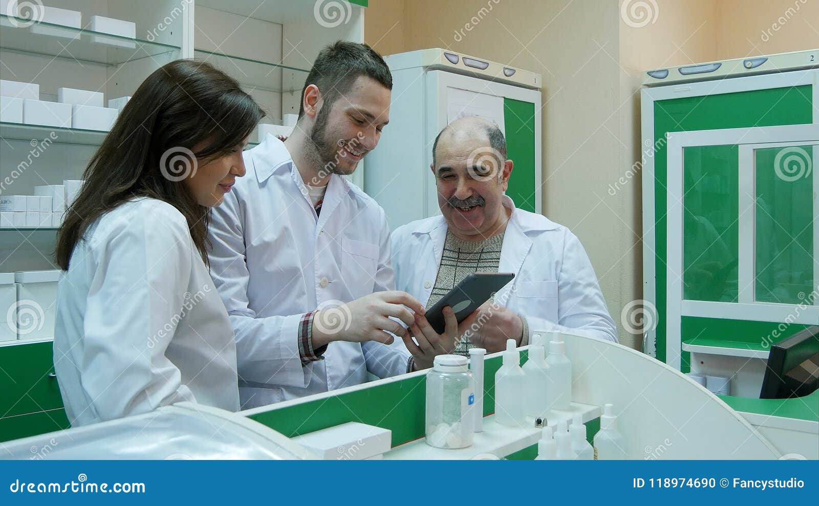 Positive Team of Pharmacist Using Tablet Pc at Pharmacy Stock Photo ...