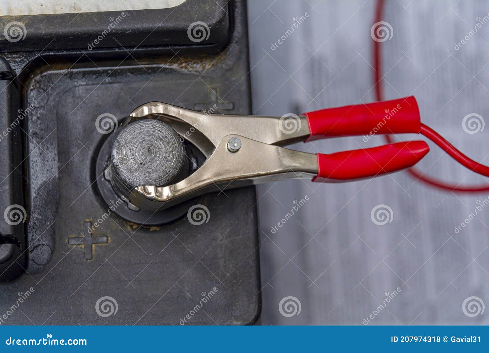 Positive Terminal of the Charger on the Battery Terminal. Charging and ...