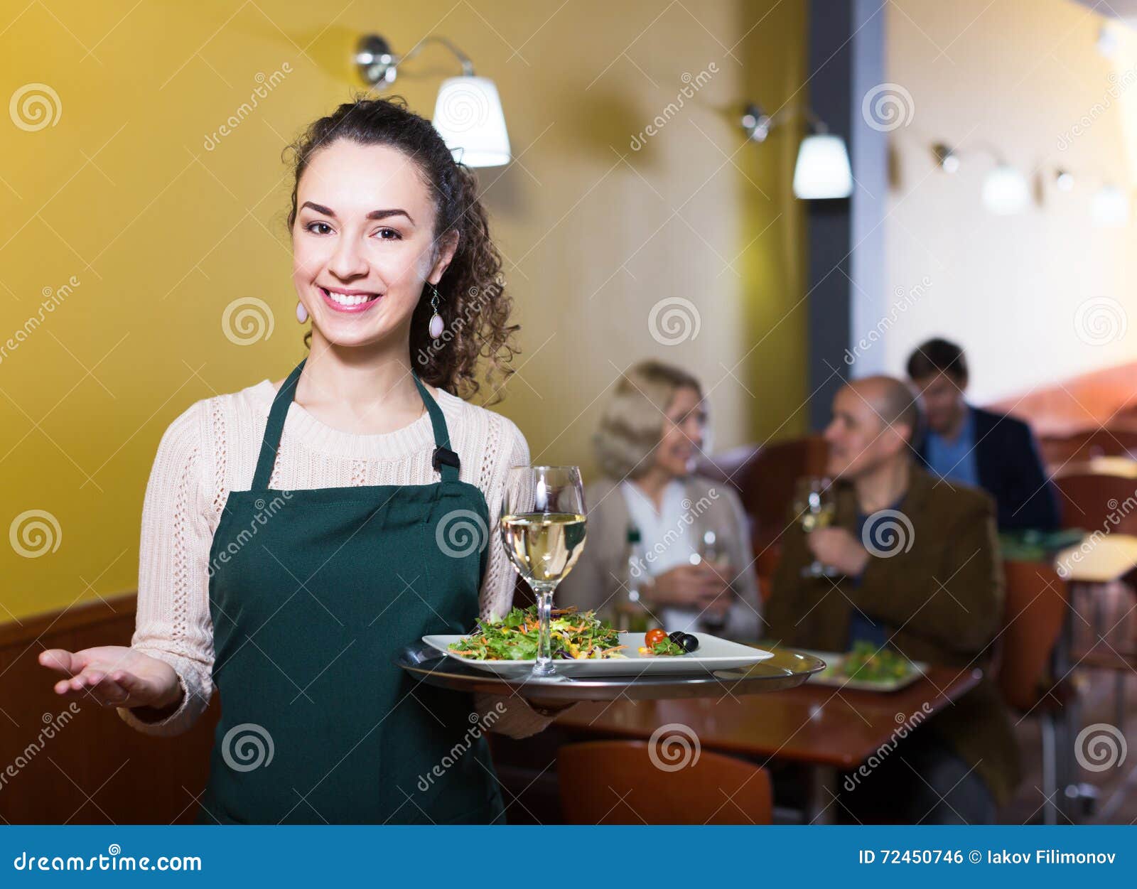 Positive Waitress Greeting Customers Stock Photo - Image of middle ...