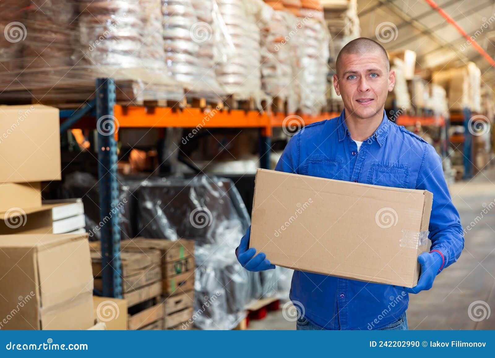 Positive Warehouse Worker Dragging Boxes on Hands Stock Photo - Image ...