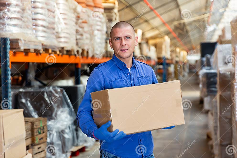 Positive Warehouse Worker Dragging Boxes on Hands Stock Photo - Image ...