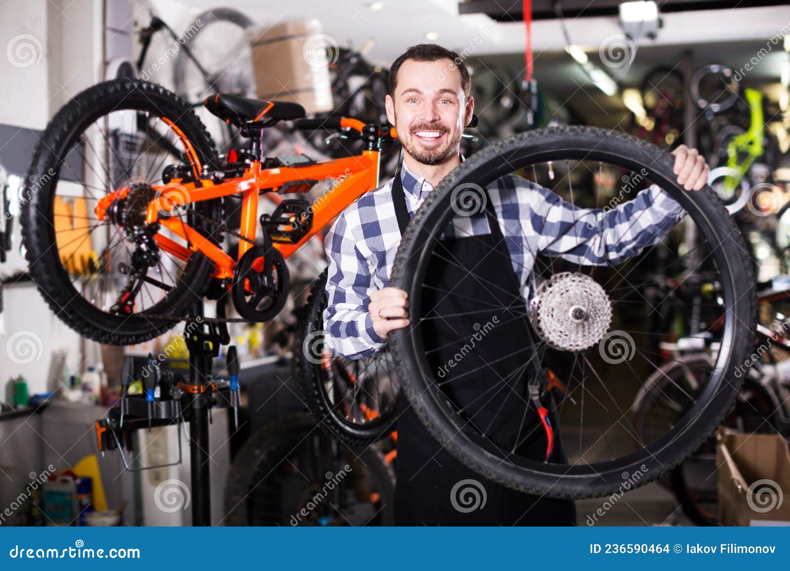 Worker with bicycle wheel stock photo. Image of race - 236590464