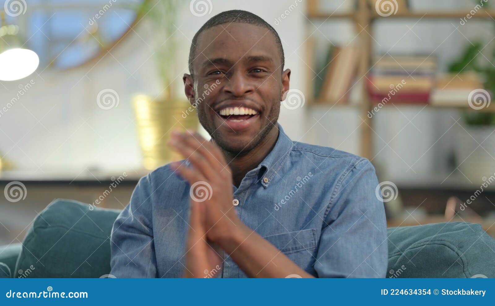 Positive Young African Man Clapping at Home Stock Photo - Image of ...