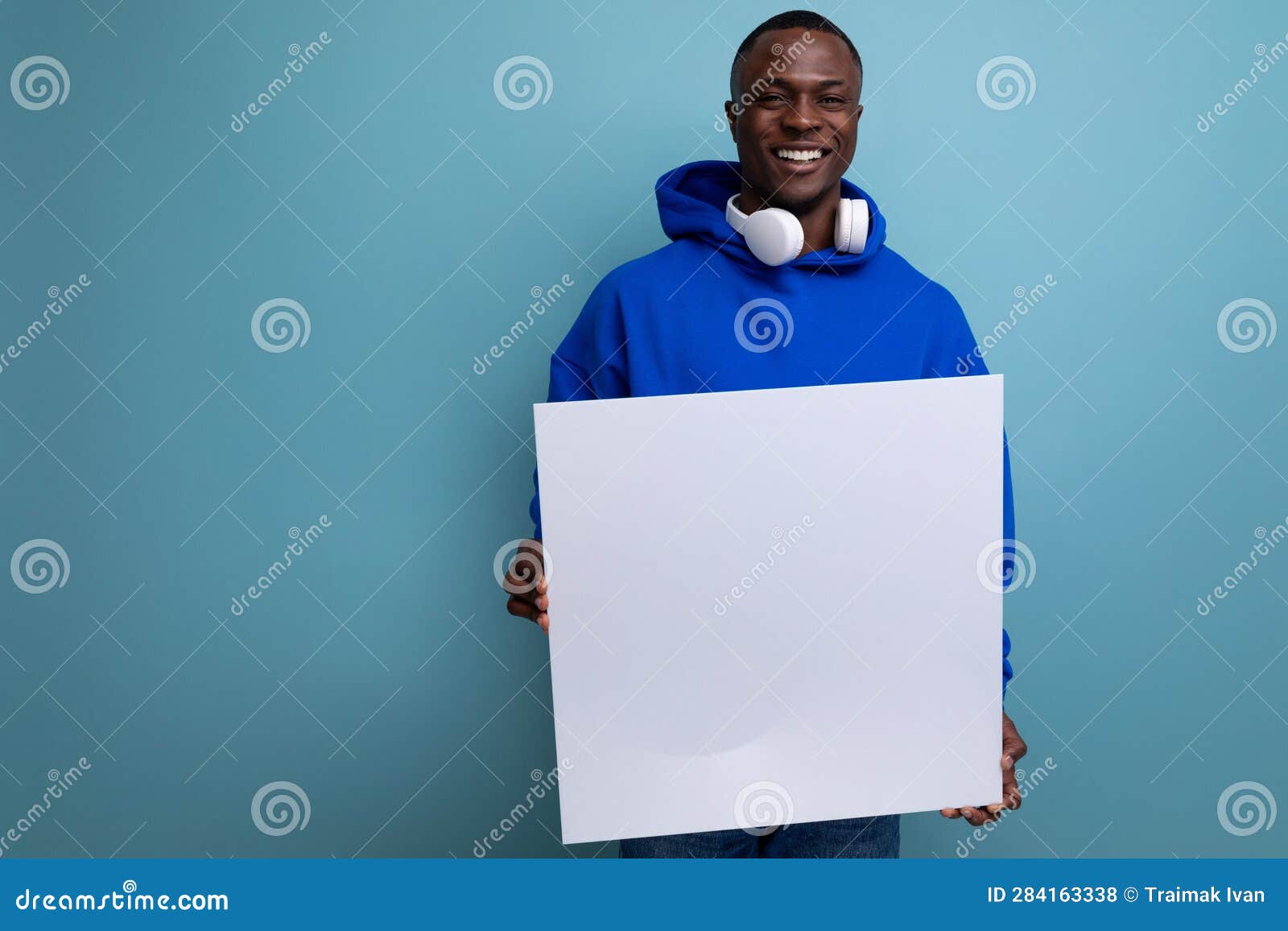 Positive Young African Man Presenting a Project on a White Sheet with a ...