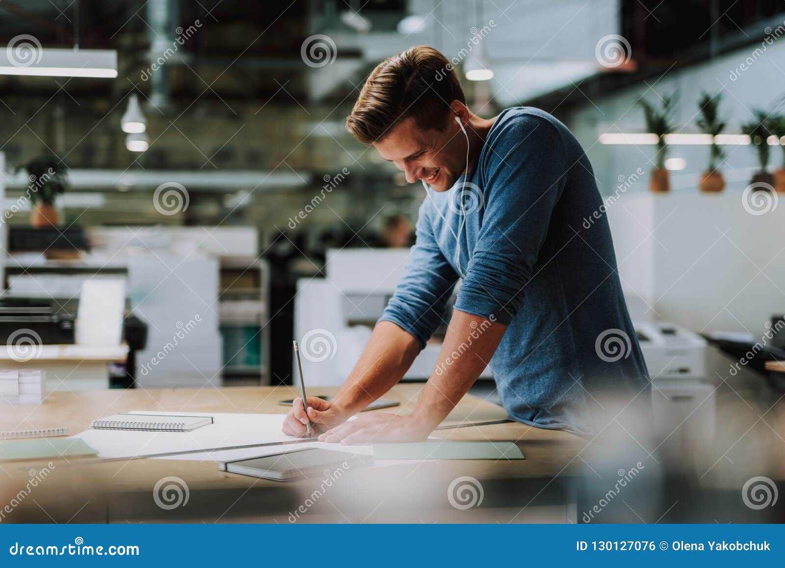 Positive Young Man Making a Drawing with Pleasure Stock Photo - Image ...