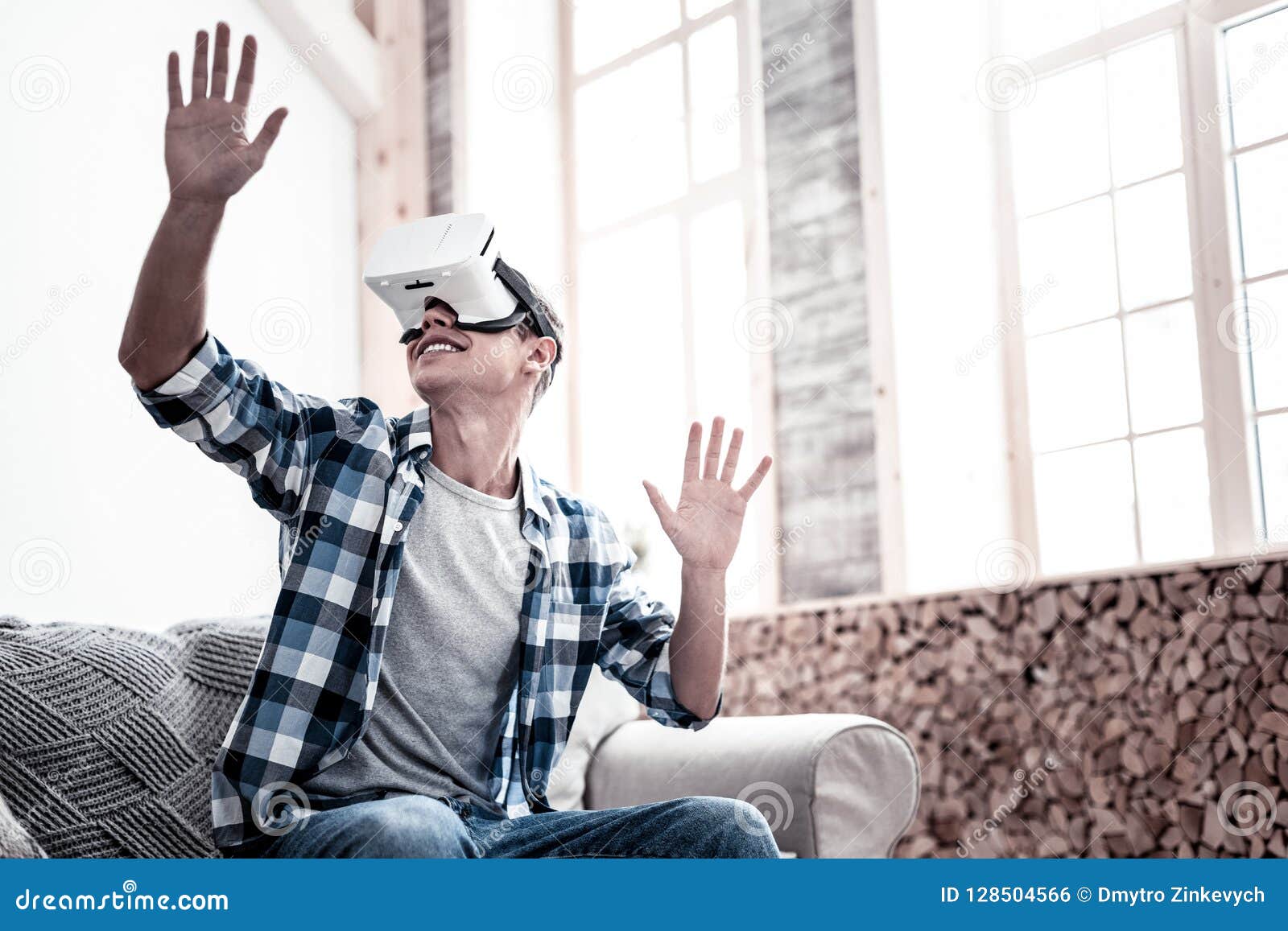 Positive Young Man Smiling while Exploring Virtual Reality at Home ...