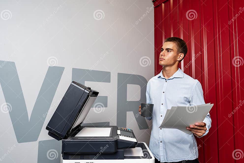 Positive Young Man Using Printer in the Modern Office Stock Image ...