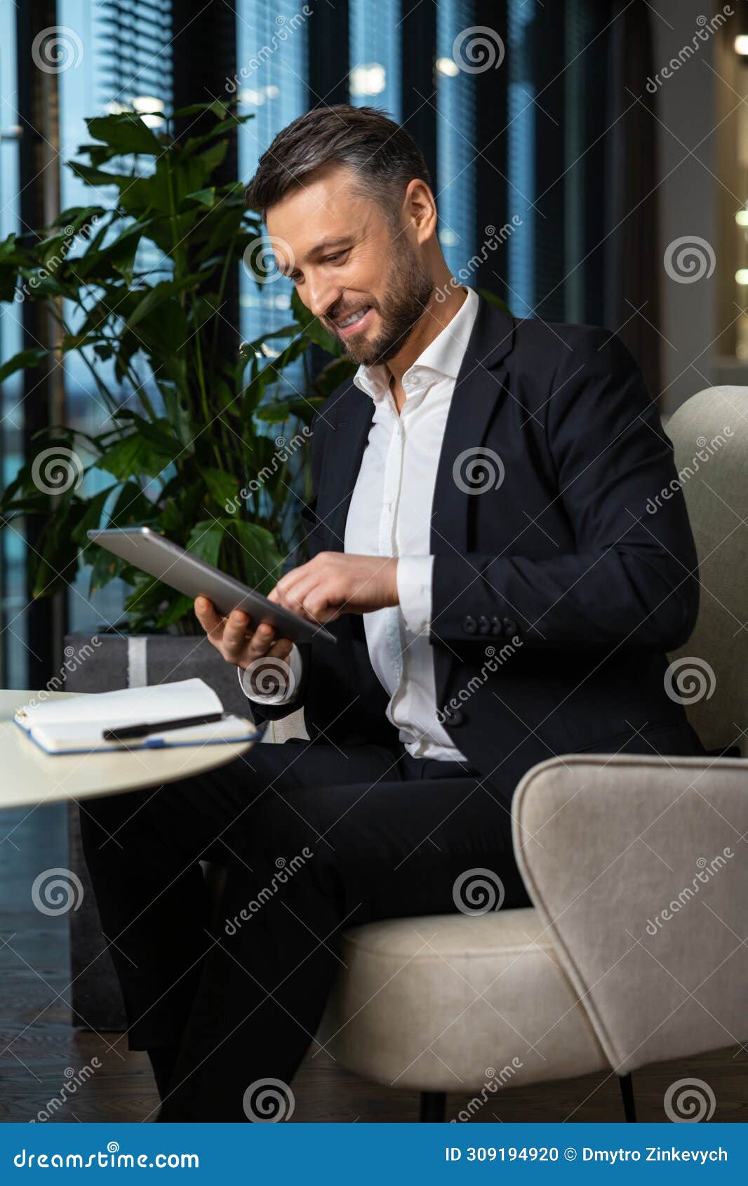 Positive Young Manager with Tablet in Hands Working in the Office Stock ...